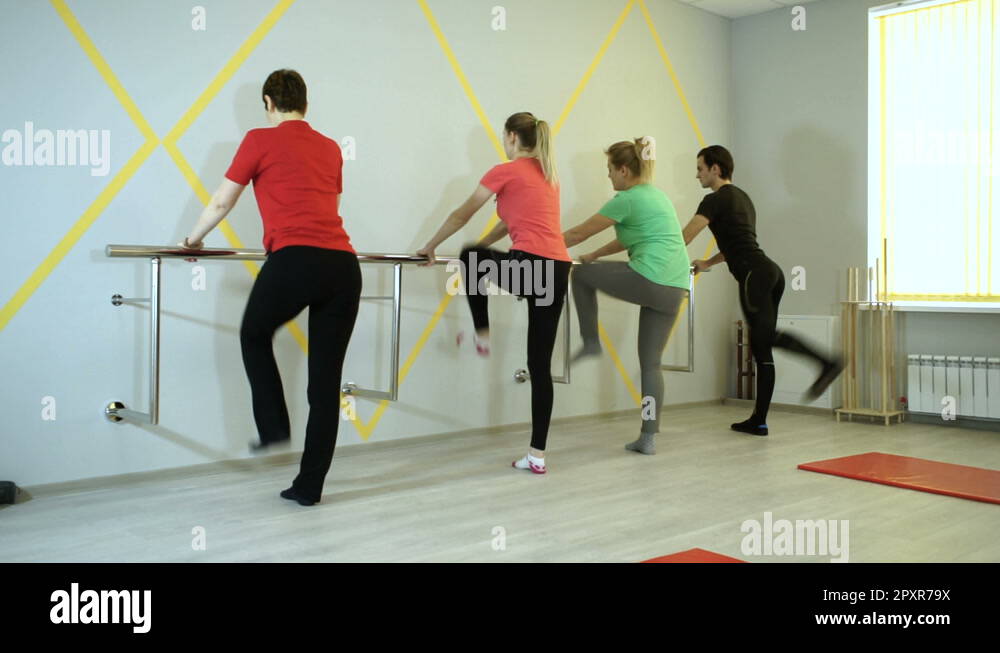 A group of people practicing exercises of gymnastics in sports hall. HD ...