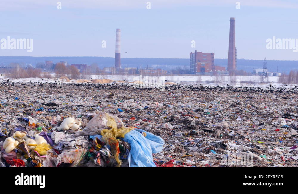 Pan of a big piles of garbage. Plastic, polyethylene in a garbage dump ...