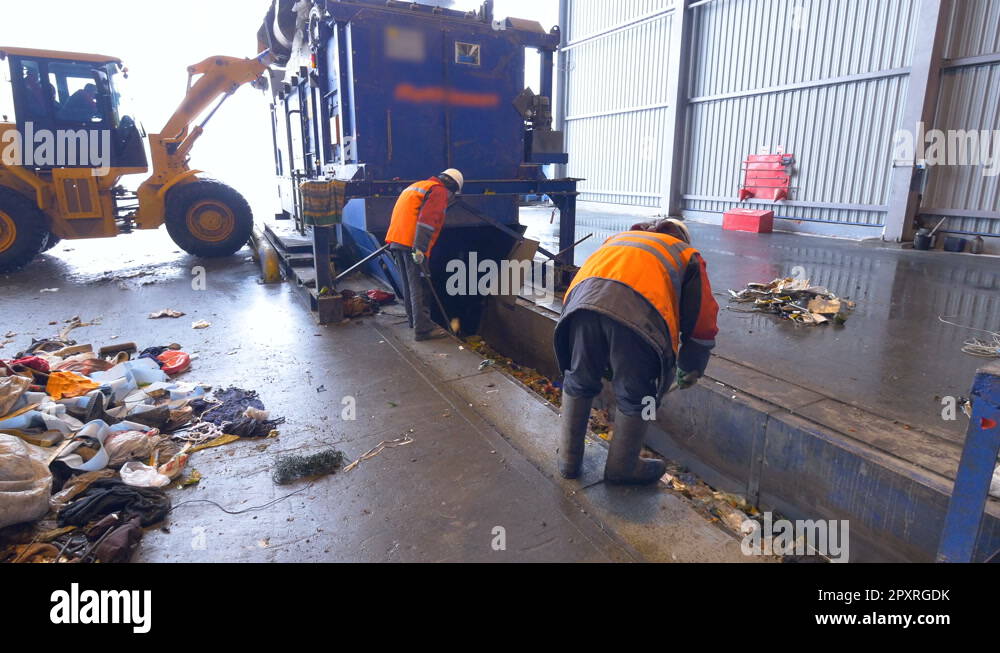 Laborers sorting trash, garbage at a recycling plant conveyor Stock Video Footage - Alamy