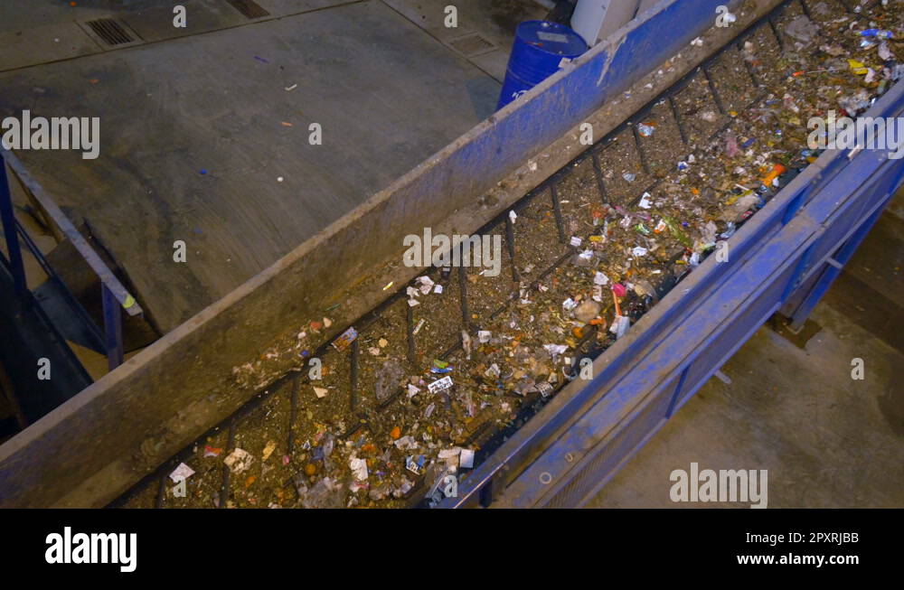 Industrial trash conveyor system. Garbage moving on conveyor. Recycling ...