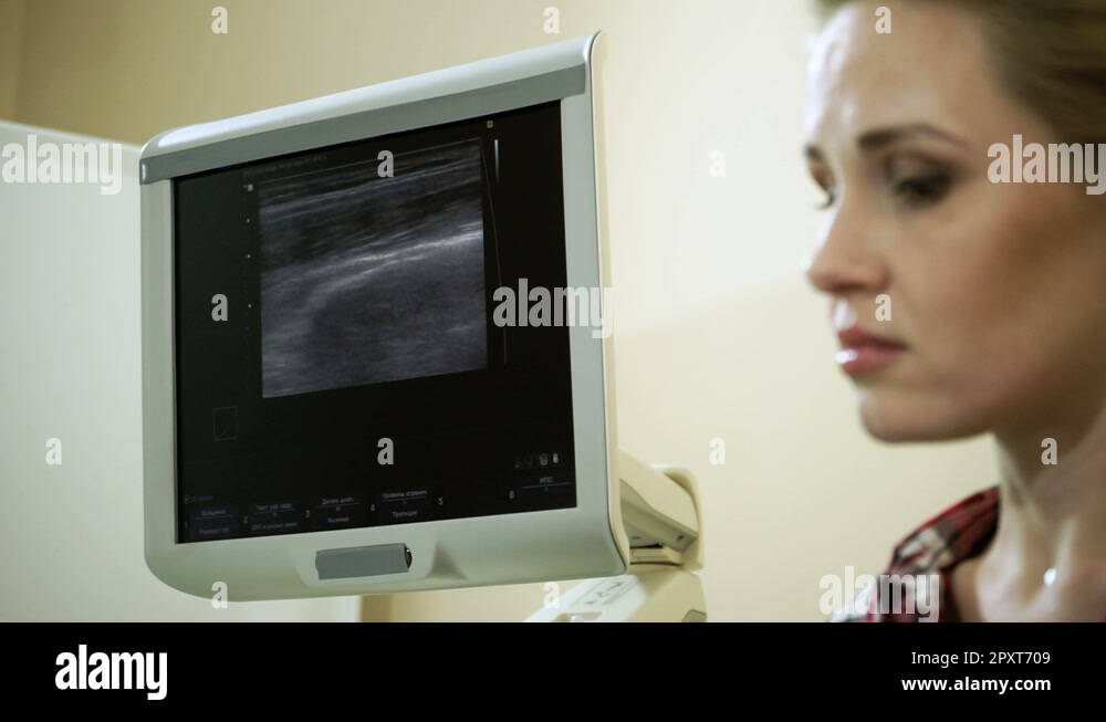 Ultrasonic scanning. The woman is on an ultrasound examination in a ...