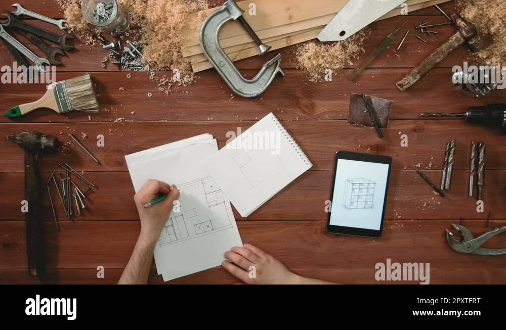 Top view craftsman hands drawing a sketch of floor plan on paper using ...