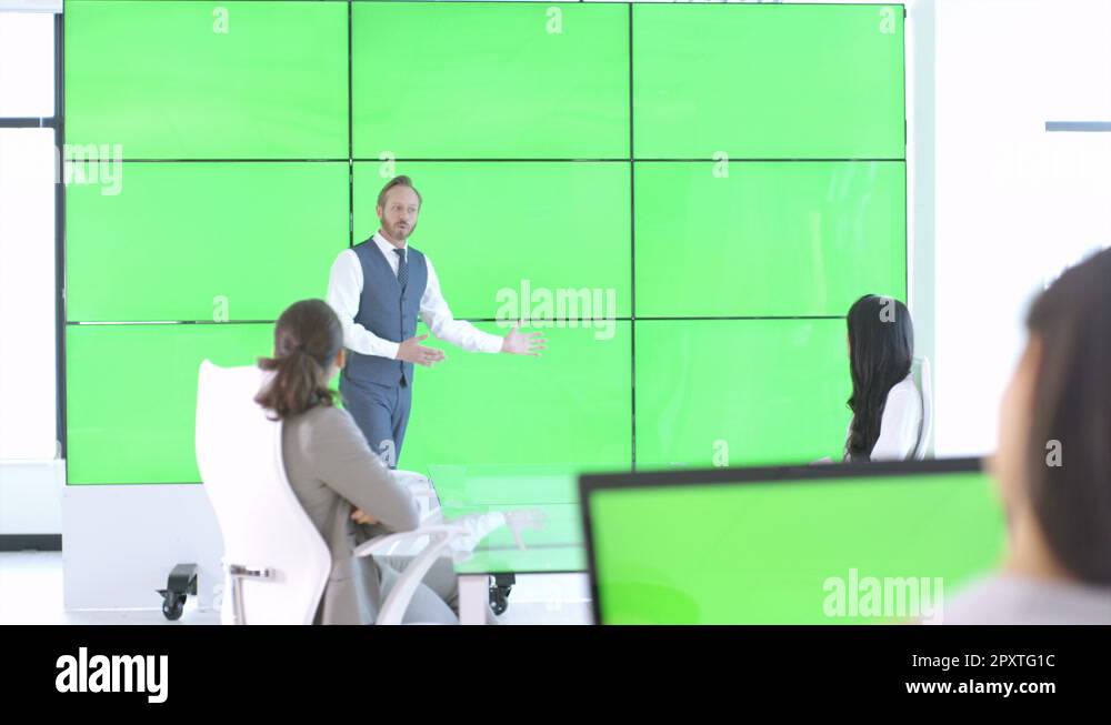 4K Business team in a meeting, man interacting with green screen video ...