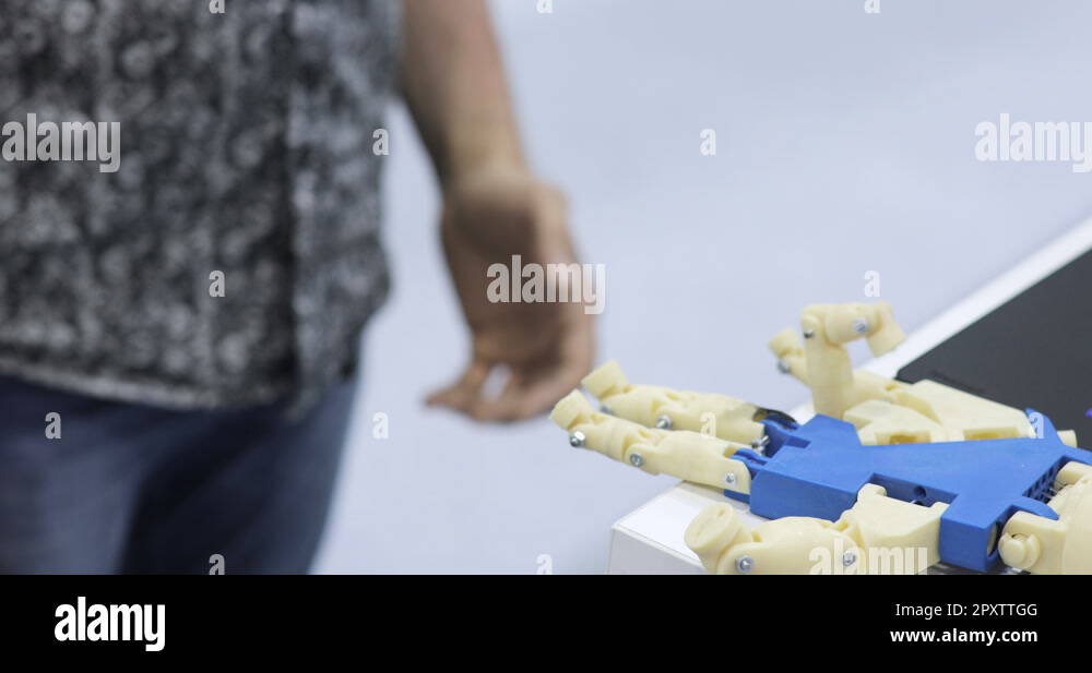 A human and a bionic hands lying beside each other. Top view. Man with ...
