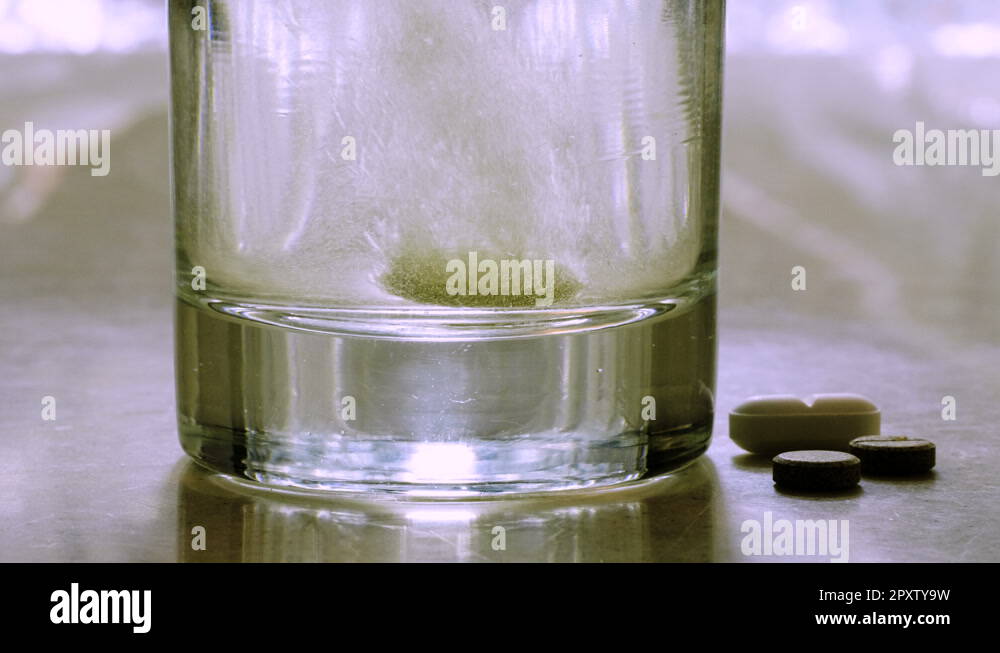 Taking medicine. Effervescent tablet dissolving in a drinking glass of water. 4K Stock Video ...