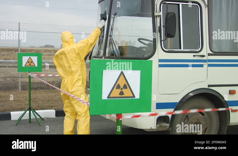 Radiation. Person in a special suit examines the bus a dosimeter Stock ...