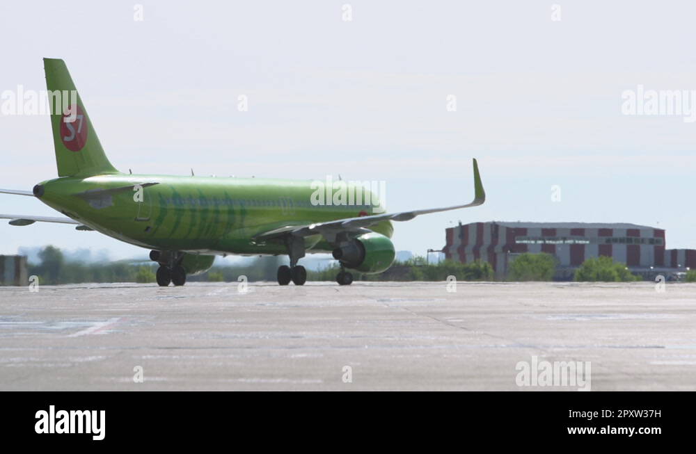 Airplane moves along runway. Airline S7 Stock Video Footage - Alamy