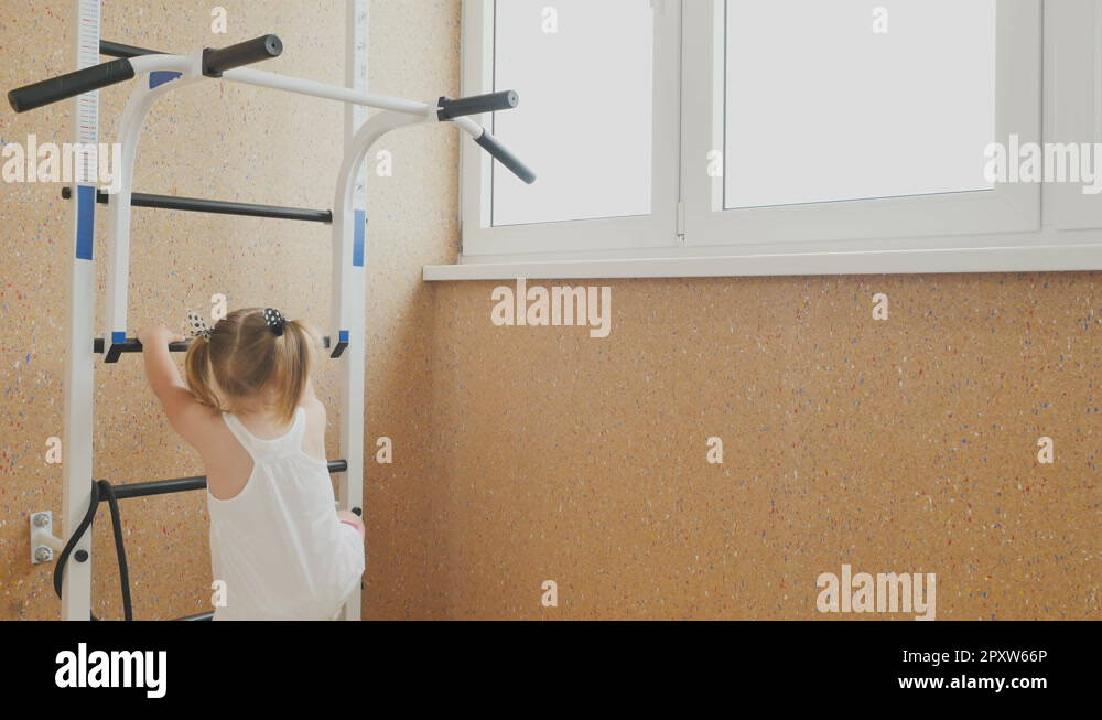Little girl triesto pull up on the horizontal bar at home Stock Video ...
