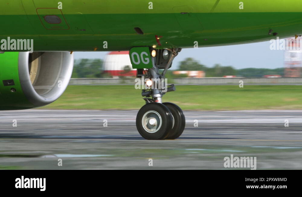 Airplane moves along runway, view to the working turbines and landing ...