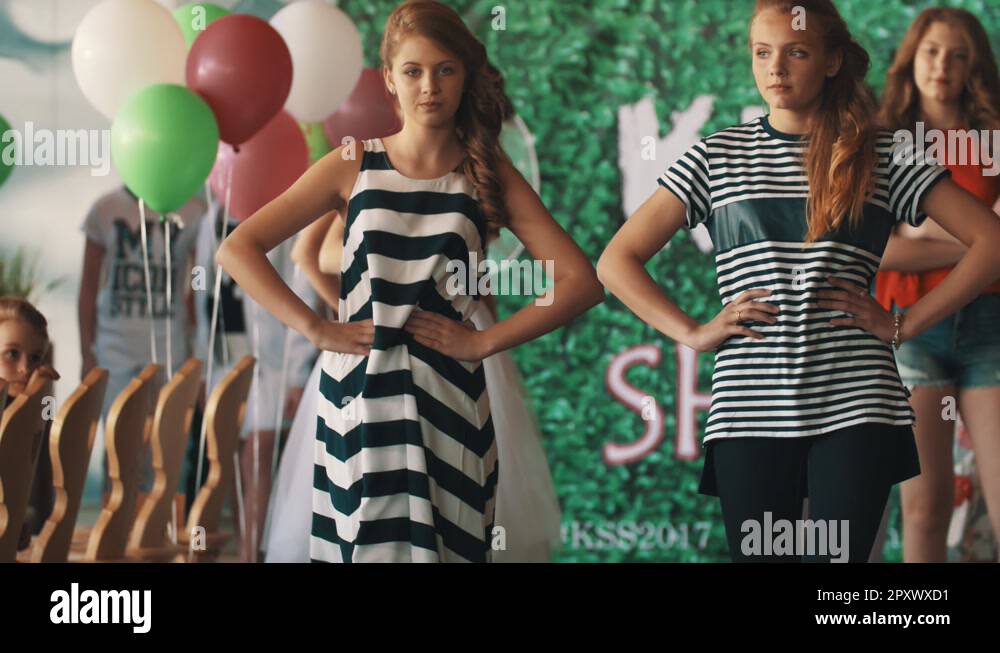 Teenage girls models showing clothes walking on catwalk at kids fashion ...