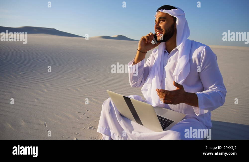 Successful Muslim Arabian UAE Sheikh architect communicates on phone ...
