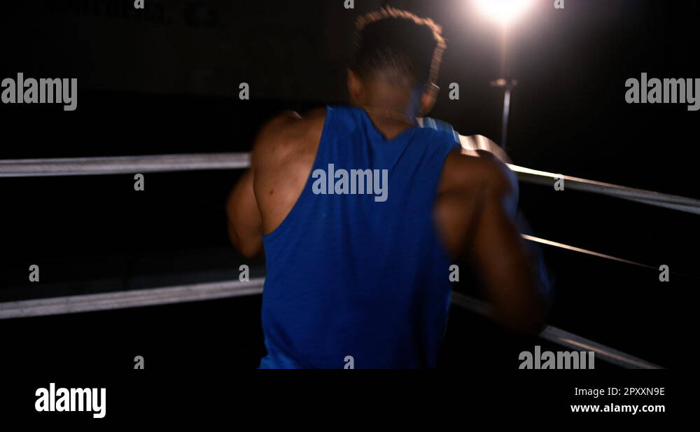 Strong man shadowboxes in an empty boxing ring at night Stock Video ...