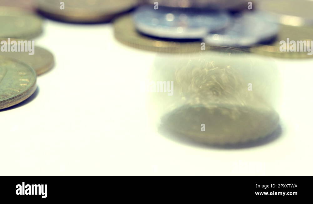Unusual background from coins of different countries. The coin rotates ...