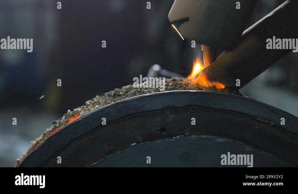 Close up of welding robots apply overlay weld protection on the pipe ...