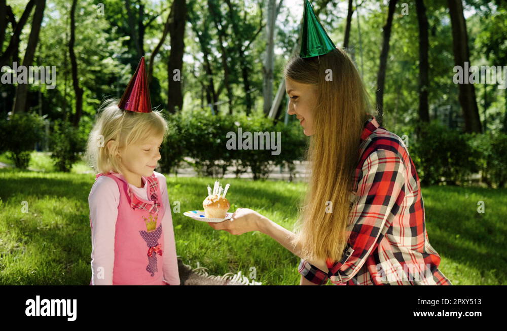 Birthday of the little girl she blowing out six candles on cake. 4K ...