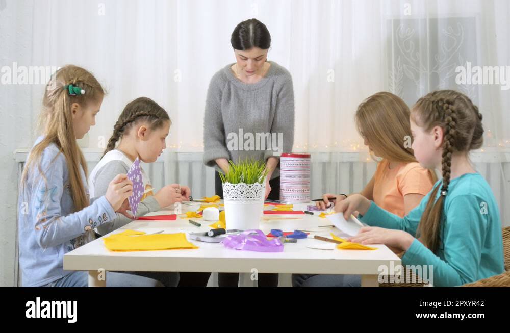 Girls at the lesson with the teacher sew a soft toy with their own ...