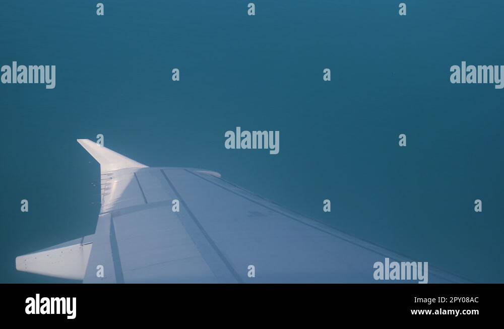 Wing of Wing of plane. A view of the sea and mountains from the plane ...