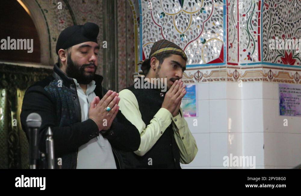 Sikh devotees praying inside Gurdwara Panja Sahib Stock Video Footage ...