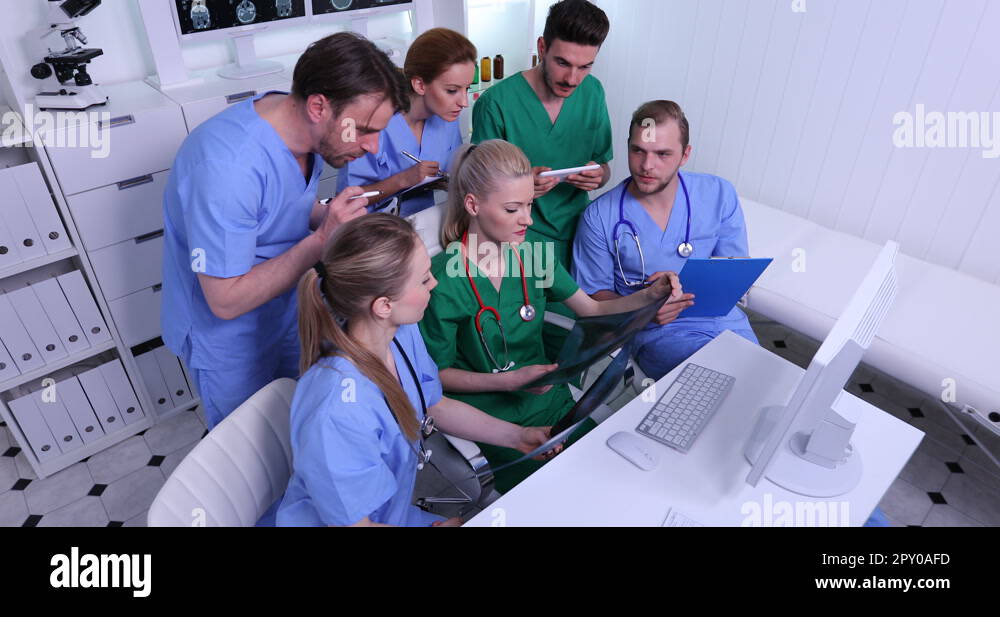 Busy Medical Doctors People Talking Evaluate Lungs Radiography in ...