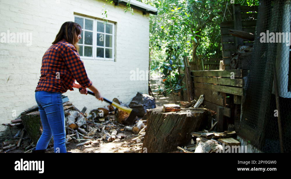 Woman chopping wood with axe 4k Stock Video Footage - Alamy