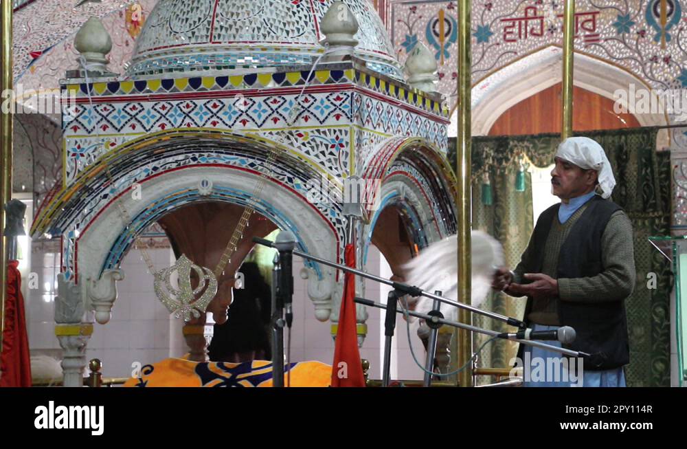 Sikh devotees fanning doing Chaur Sahib inside Gurdwara Panja Sahib ...
