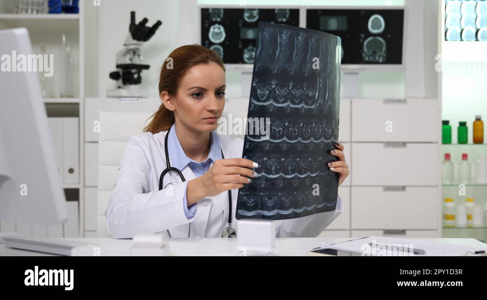 Medical Doctor Woman Holding and Examine a Ct Scan Computer Scanner ...