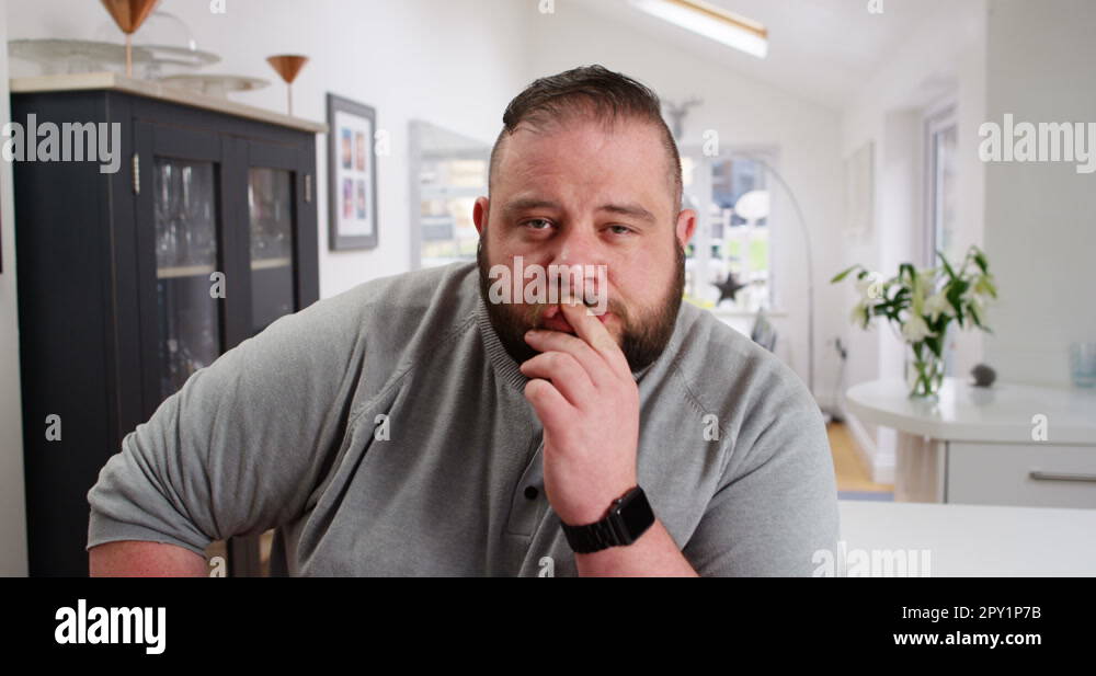 4K Man listening to very boring conversation via video call, staring at ...