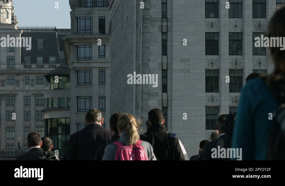Large crowd of pedestrians walk over London Bridge 32. HD version Stock ...