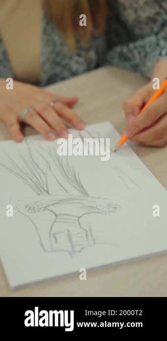 Female designer drawing a sketch of clothes on a piece of paper. High ...