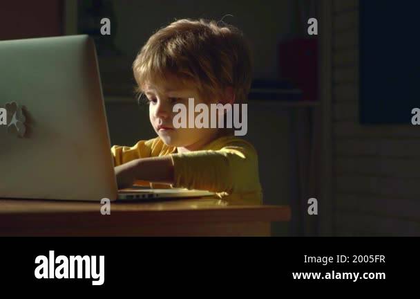 Baby with laptop. Blond baby working with laptop at home. Smart little ...