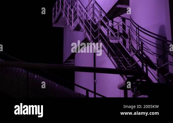 A staircase with a purple hue. The stairs are illuminated by a light ...