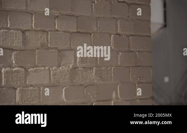 A brick wall with a white background. The wall is made of white bricks ...