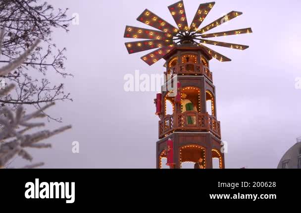 A traditional German Christmas pyramid adorned with glowing lights ...