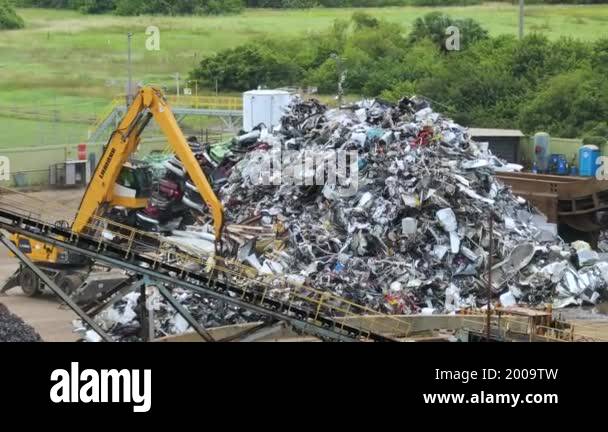 Industrial claw cranes working at vehicle utilization junkyard. Car ...