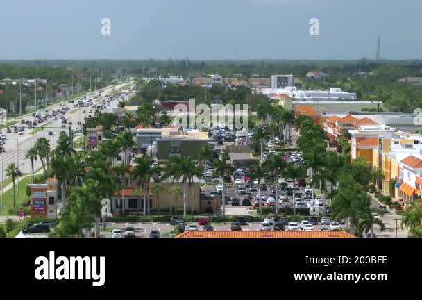 Strip mall plaza in North Port, Florida with traffic driving cars. USA ...