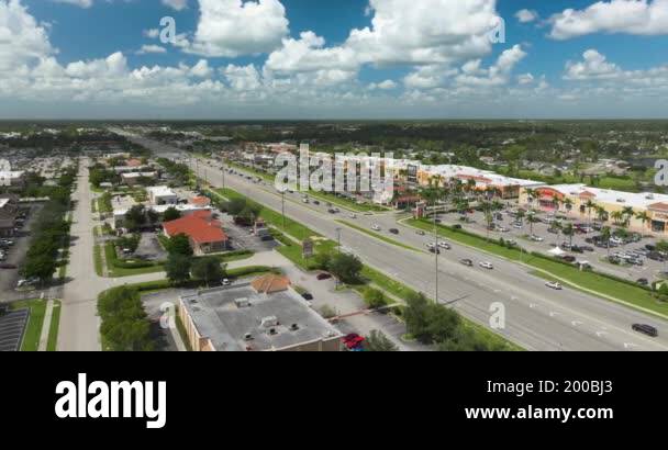 Wide highway with shopping malls and small businesses in North Port ...