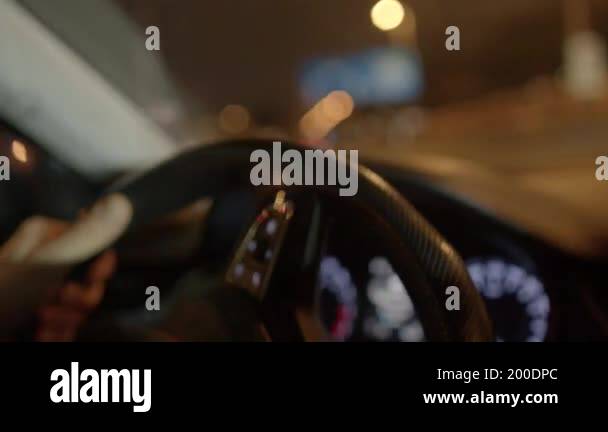 An interior view of a cars steering wheel can be observed while driving ...