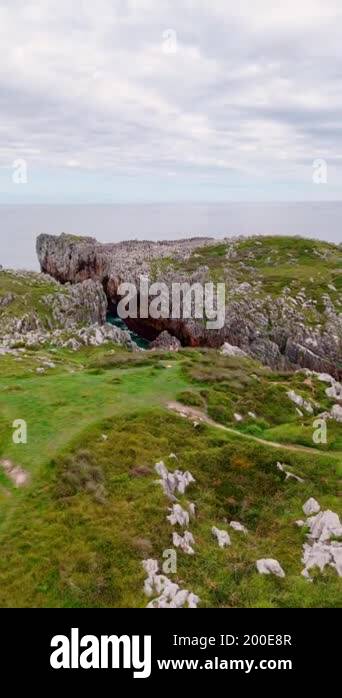 Flying away from the rocks at the coast with spiky stones sticking out ...