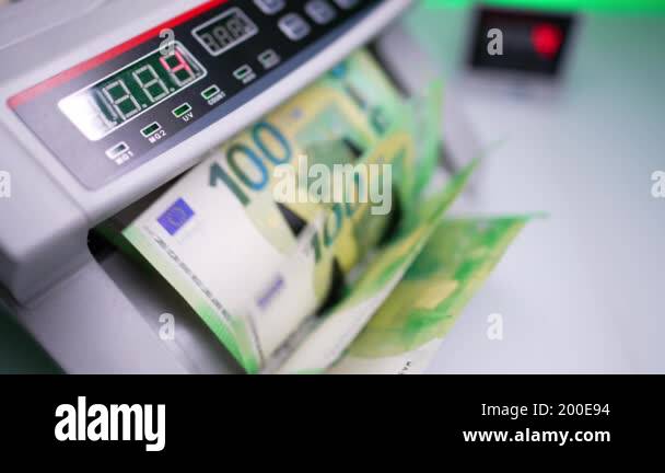 Blades of cash counting machine rotating empty. Green one hundred euro ...