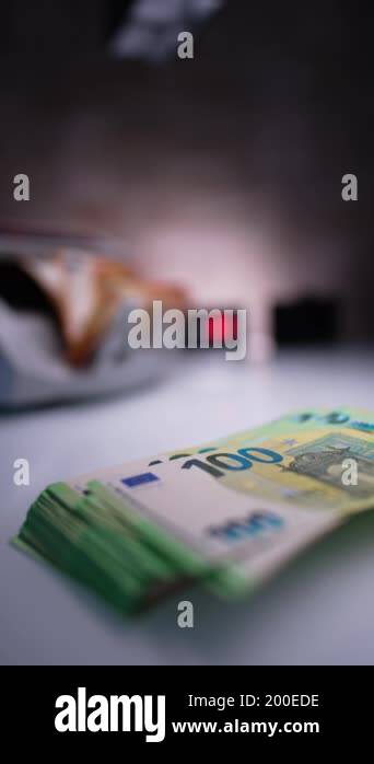 Stack of green one hundred euro bills lies on the desk. Cash counting ...