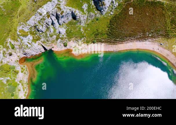 Turquoise waterscape of the mountain lake sparkling in the bright sun ...