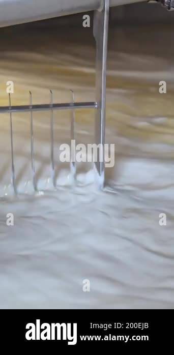 Process of making butter on a milk farm. Industrial equipment mixing ...