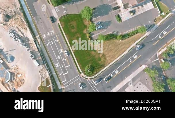 Aerial view shows busy urban intersection with green park area ...