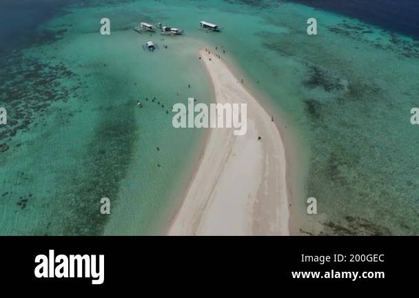 An aerial view showcasing a picturesque sandbar surrounded by turquoise ...