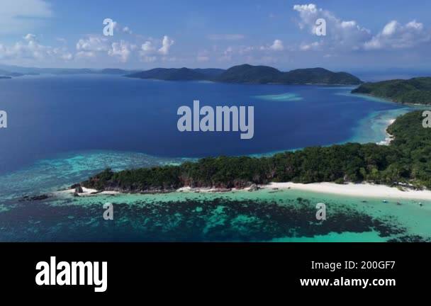 A breathtaking aerial view of a tropical island surrounded by turquoise ...