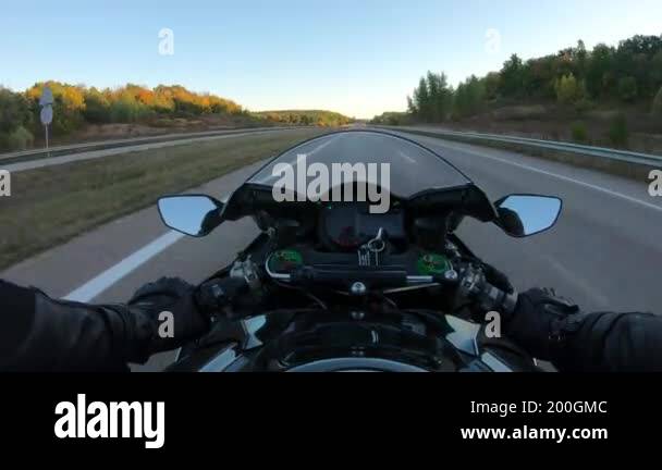 The viewpoint of motorcyclist driving motorbike at speed highway. Point ...