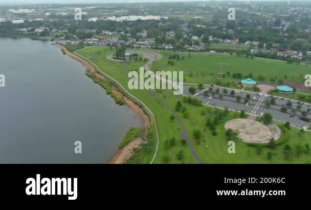 Scenic park showcases wide open spaces, walking paths, trees lining ...