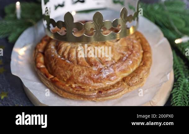 One royal galette with a golden crown on top lie on a gray background ...