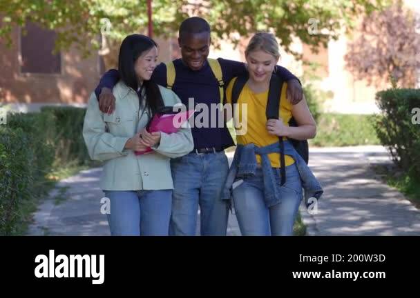 Young university students enjoying a slow motion walk on campus ...