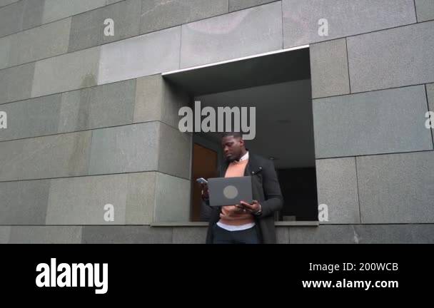 Slow motion video of a young african entrepreneur using a laptop and ...